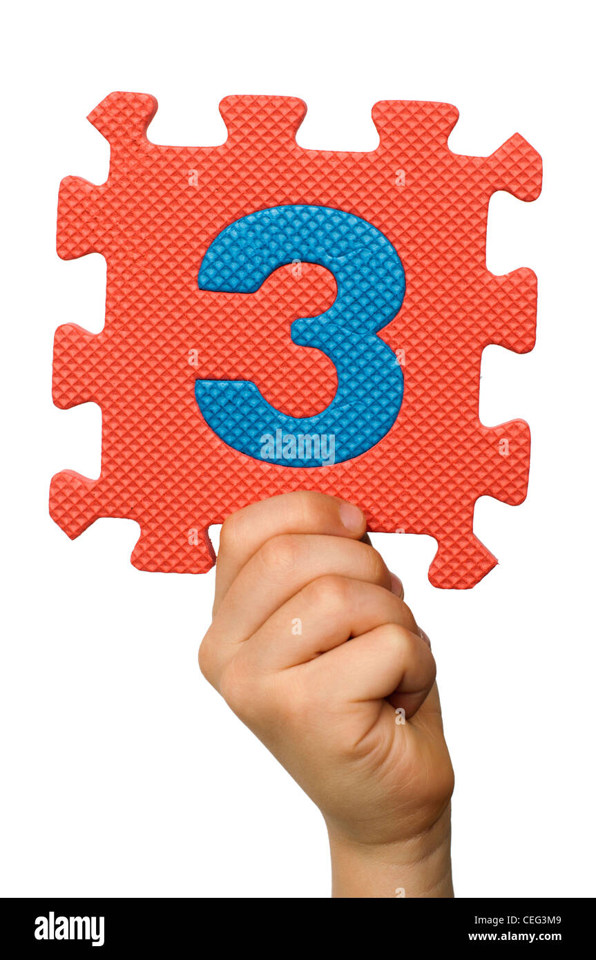 Children hand holding the number Three. White isolated multicolor ...