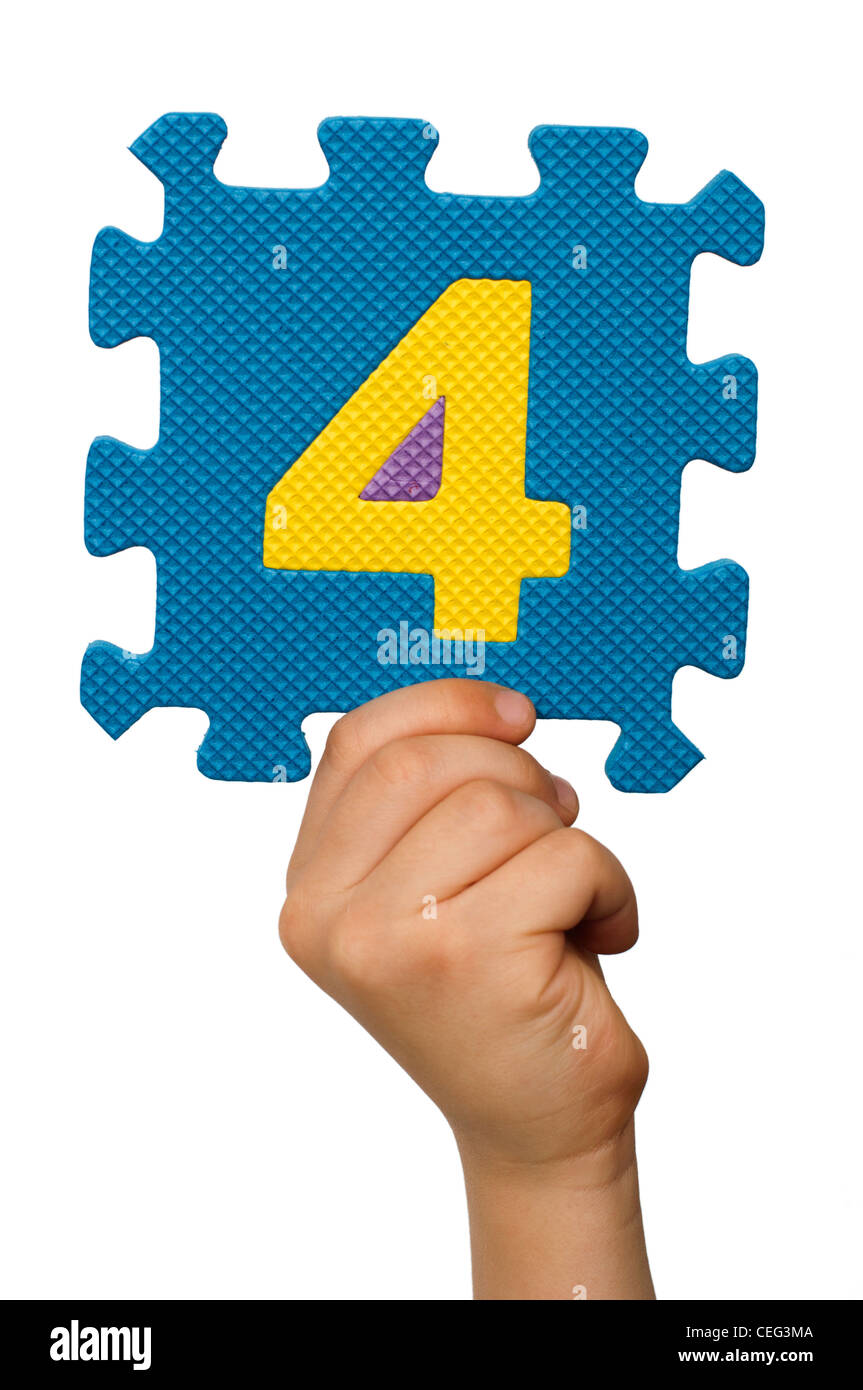 Children hand holding the number Four. White isolated multicolor number ...