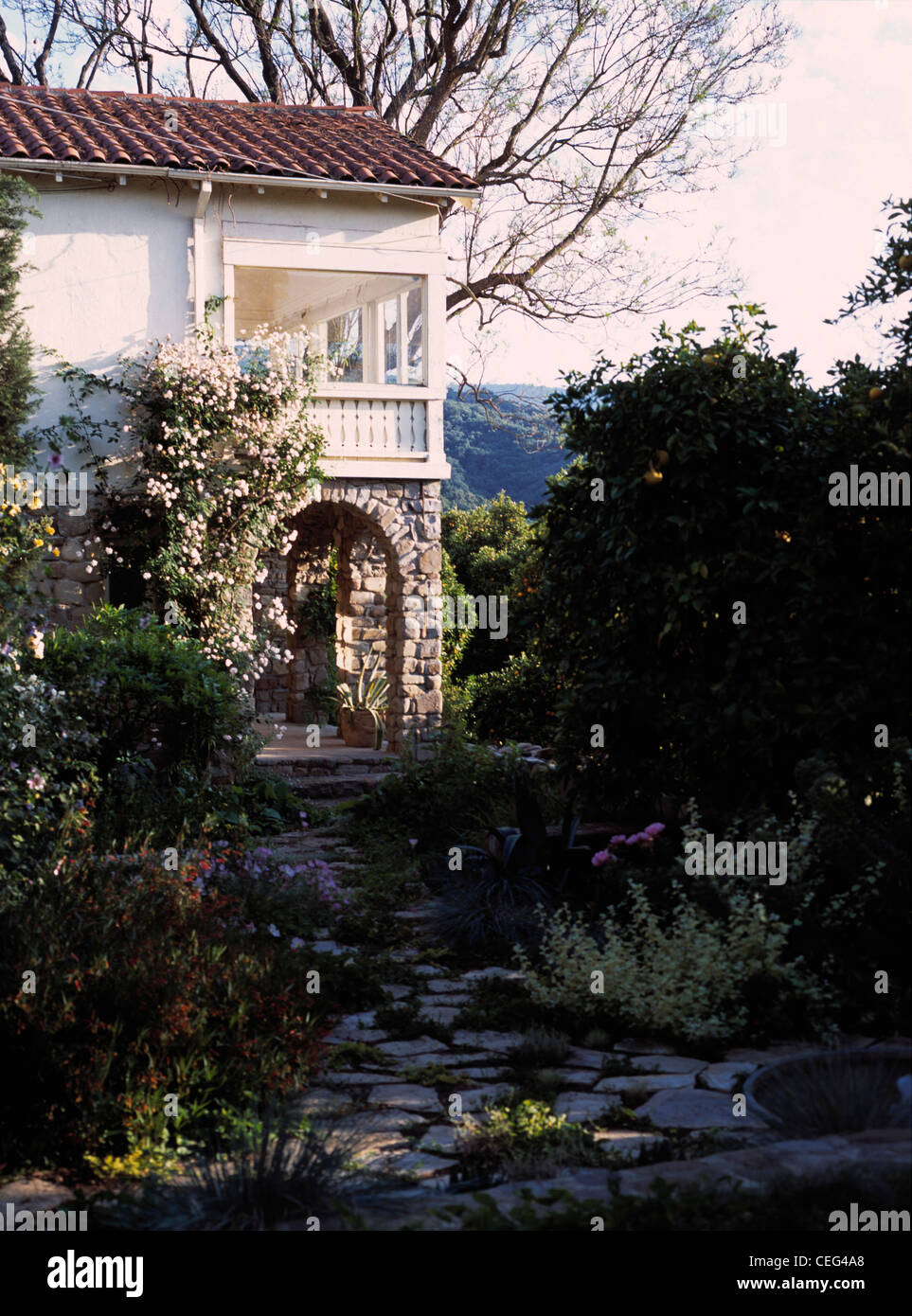 Balcony above veranda Small, traditional house in California with trees ...