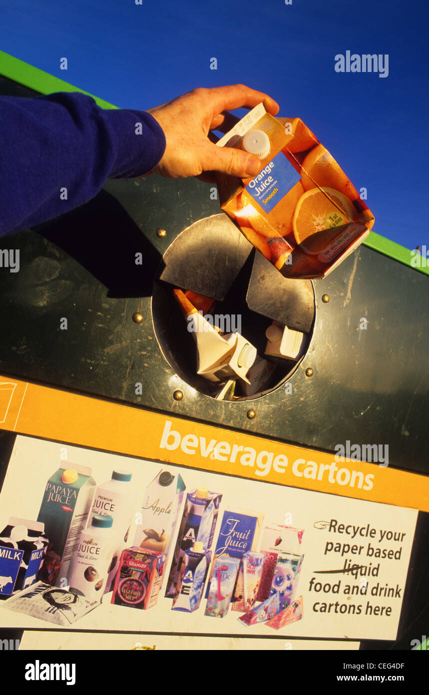 man putting drinks carton into recycling bin uk Stock Photo - Alamy