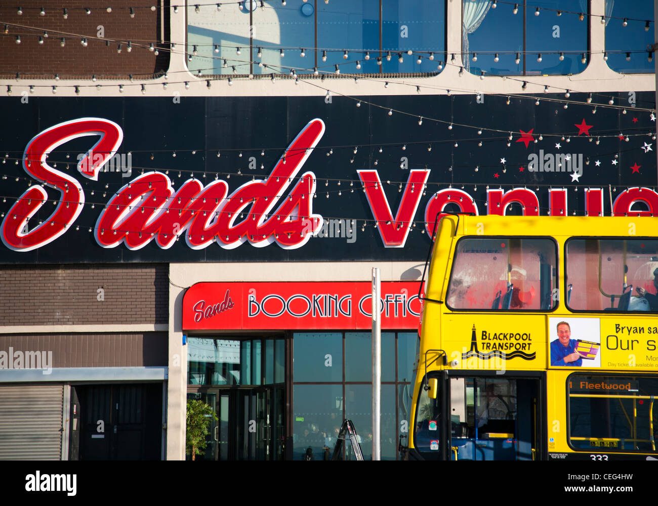 Blackpool bus and colourful signs on the promenade Stock Photo - Alamy
