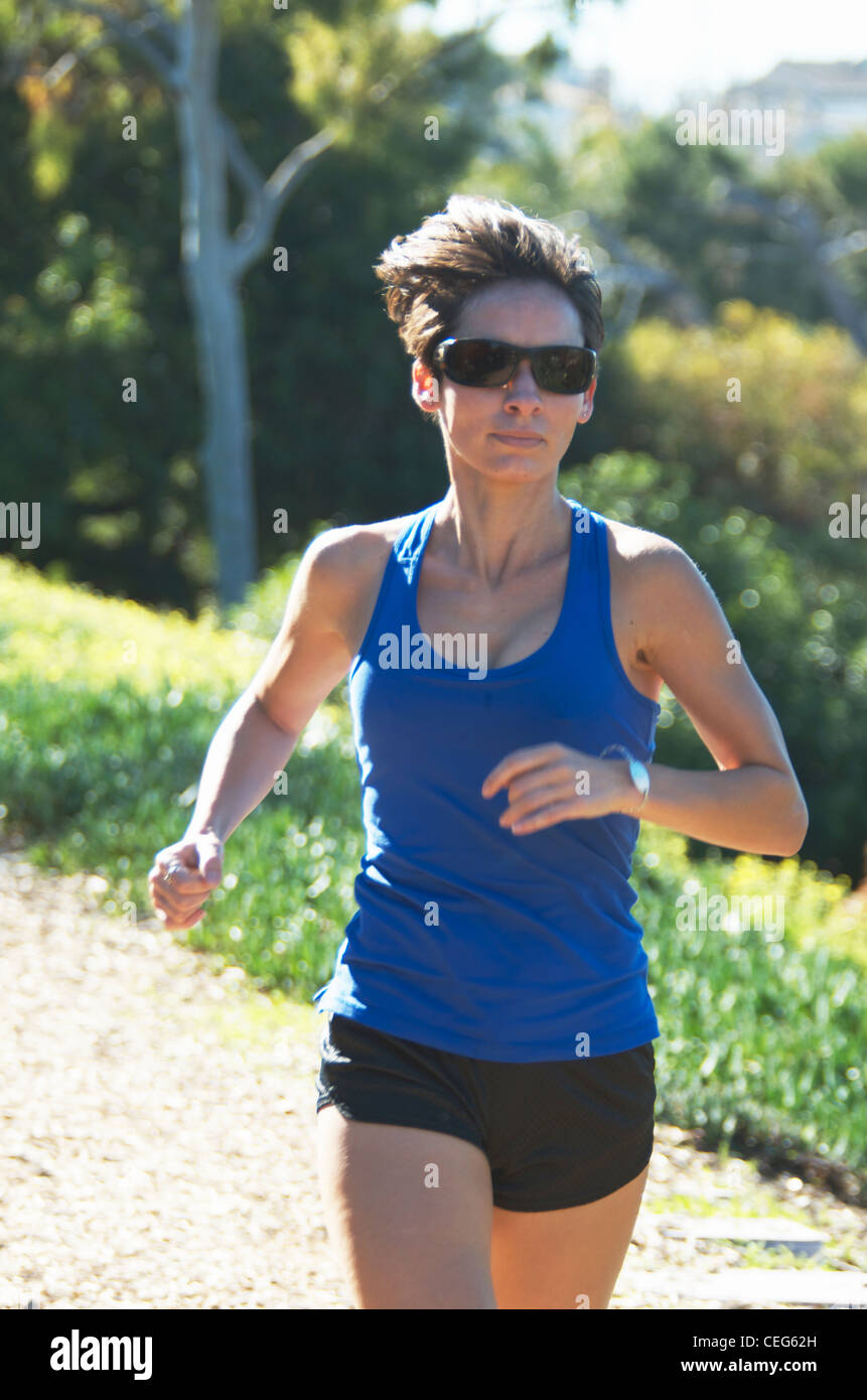 A woman running on a path Stock Photo - Alamy