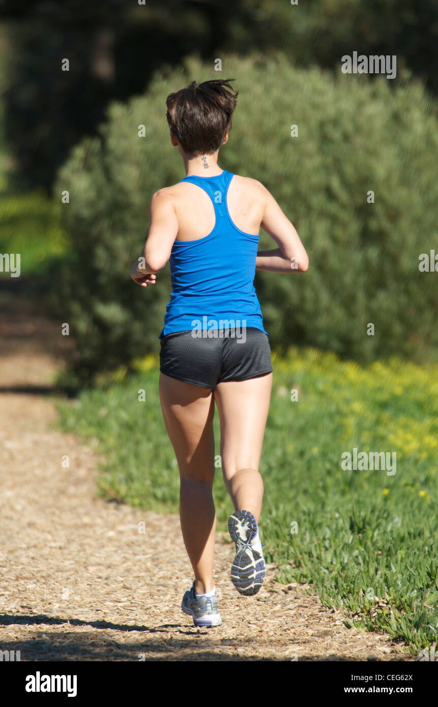 A woman running on a path Stock Photo - Alamy