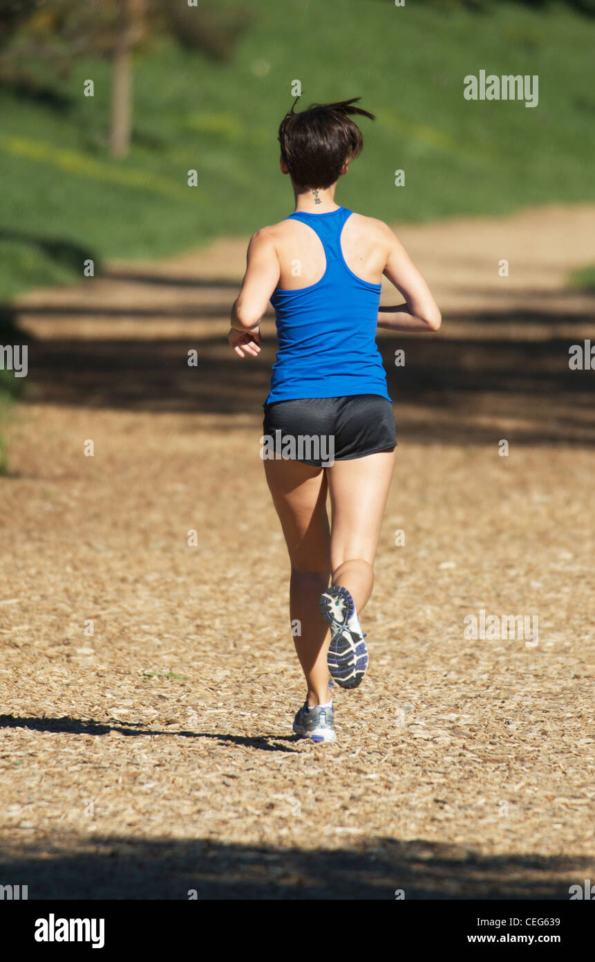 A woman running on a path Stock Photo - Alamy