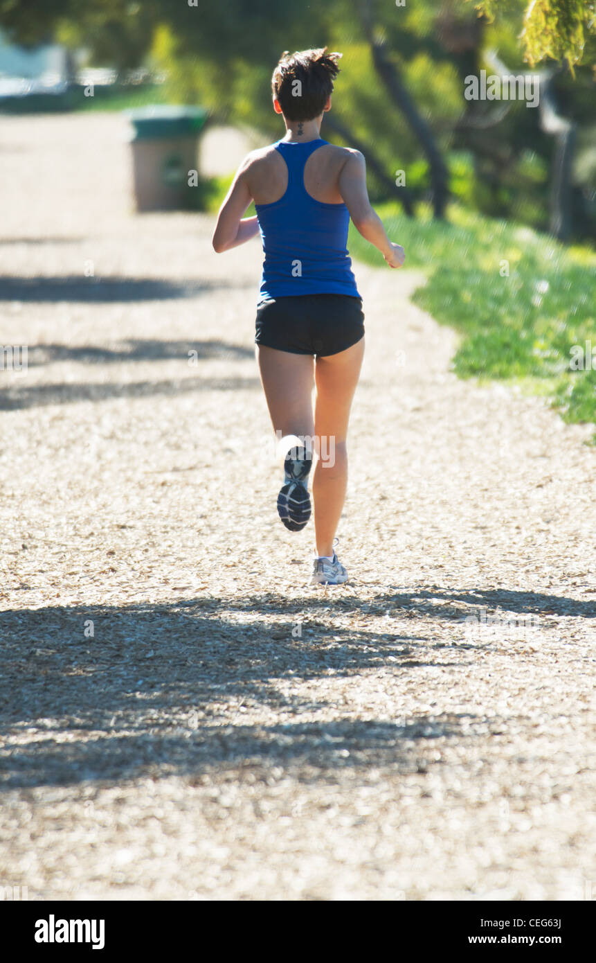 A woman running on a path Stock Photo - Alamy