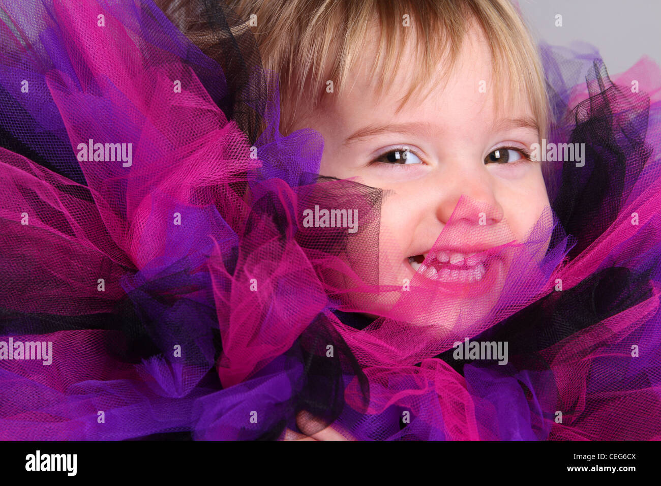 3 Year Old girl. Smiling face with fabric around Stock Photo - Alamy