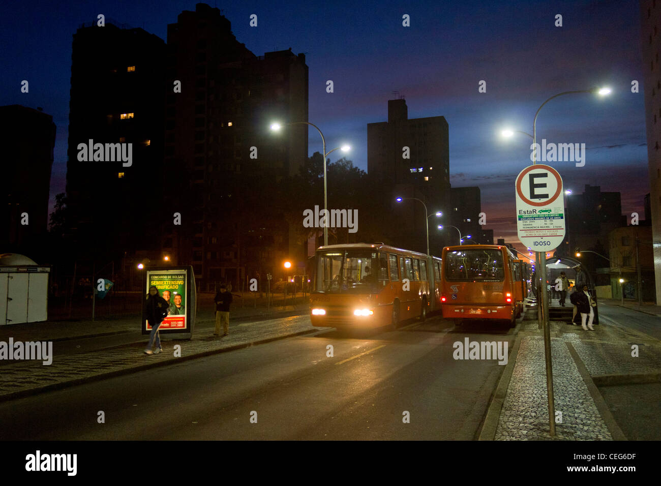 Curitiba's bus system at down. Express red bus stopping at on tube ...