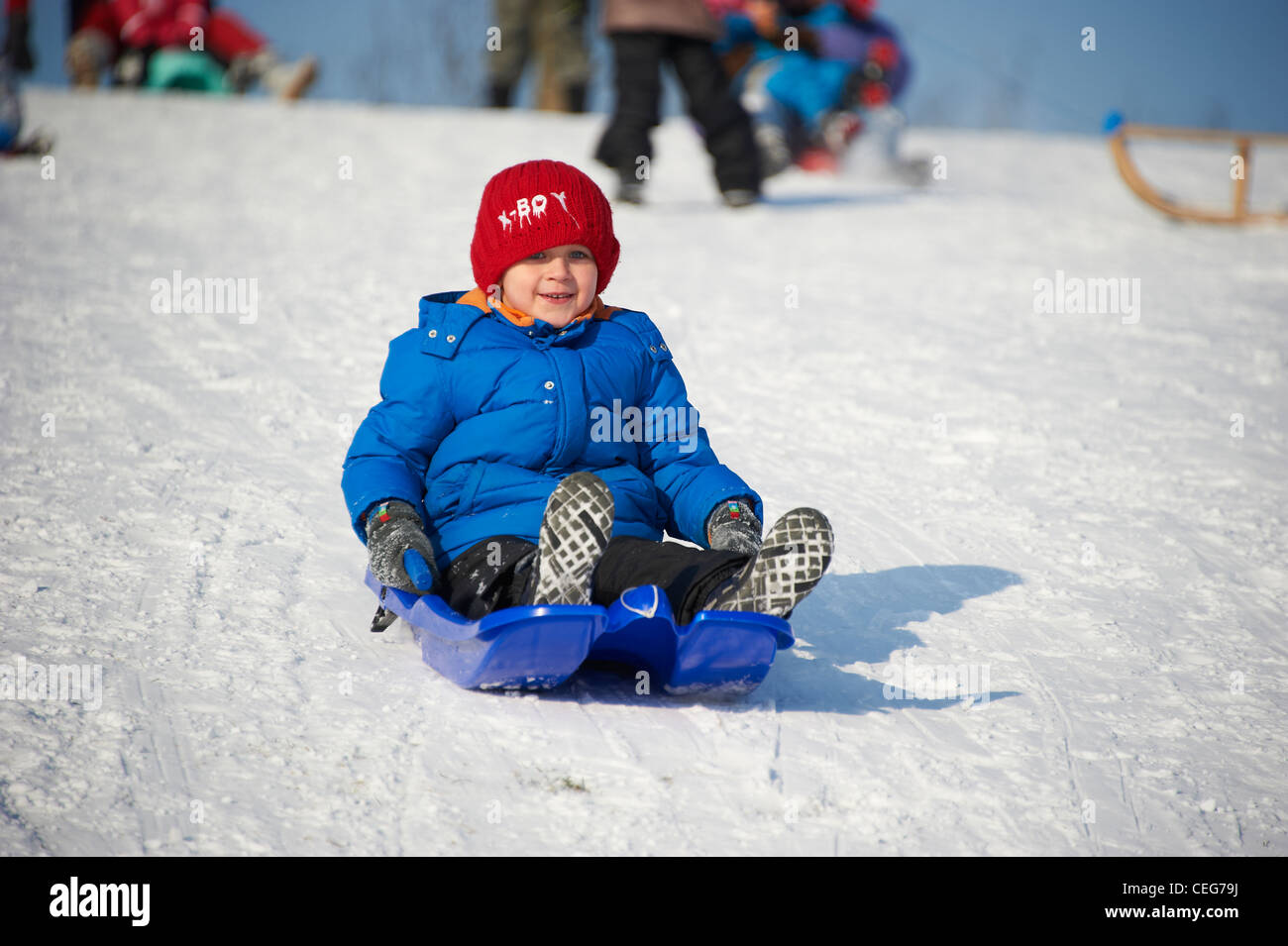 A child little boy sledding downhill winter Stock Photo - Alamy