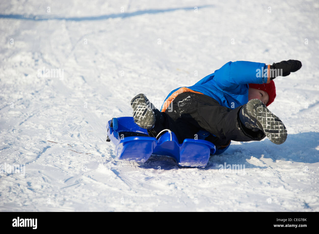 A child little boy sledding downhill winter Stock Photo - Alamy