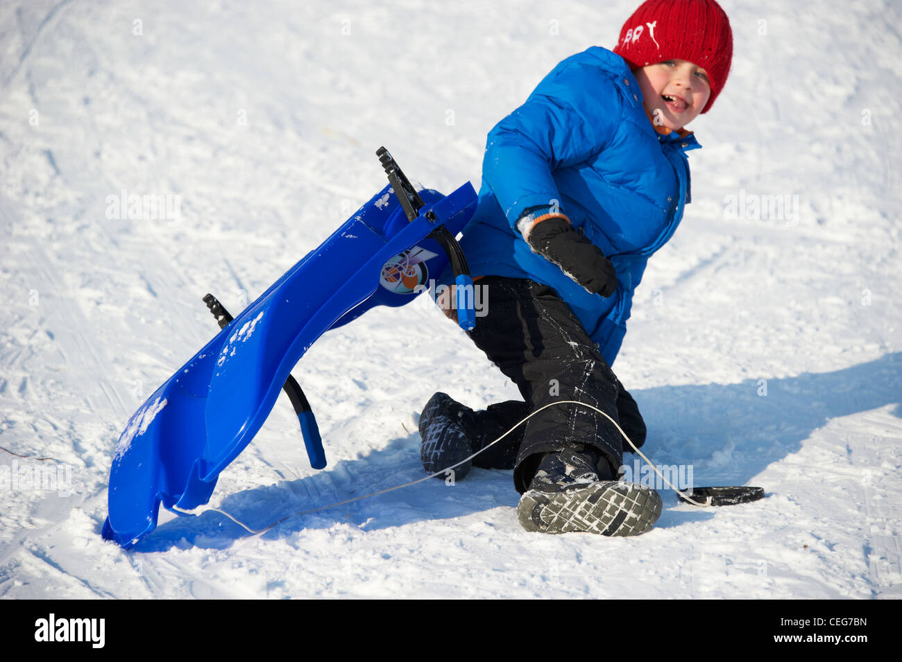 A child little boy sledding downhill winter Stock Photo - Alamy