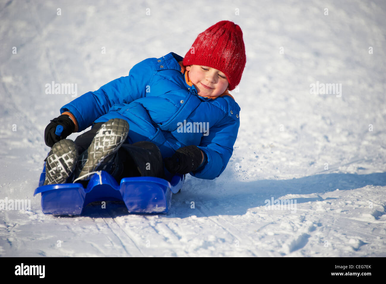 A child little boy sledding downhill winter Stock Photo - Alamy