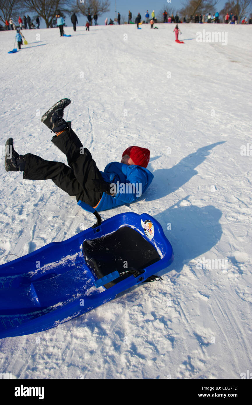 A child little boy sledding downhill winter Stock Photo - Alamy