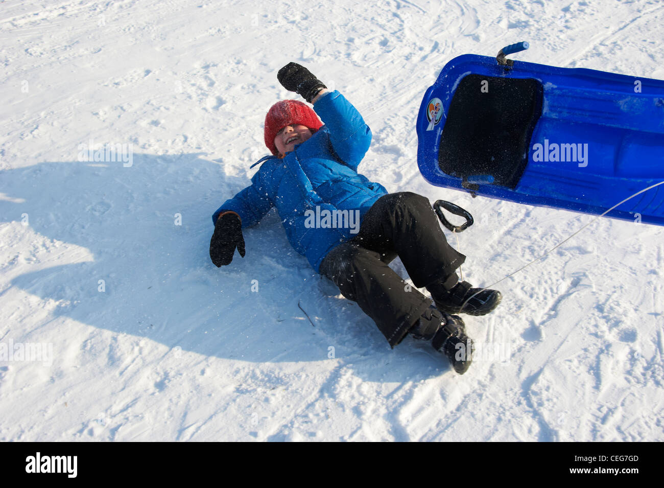 A child little boy sledding downhill winter Stock Photo - Alamy