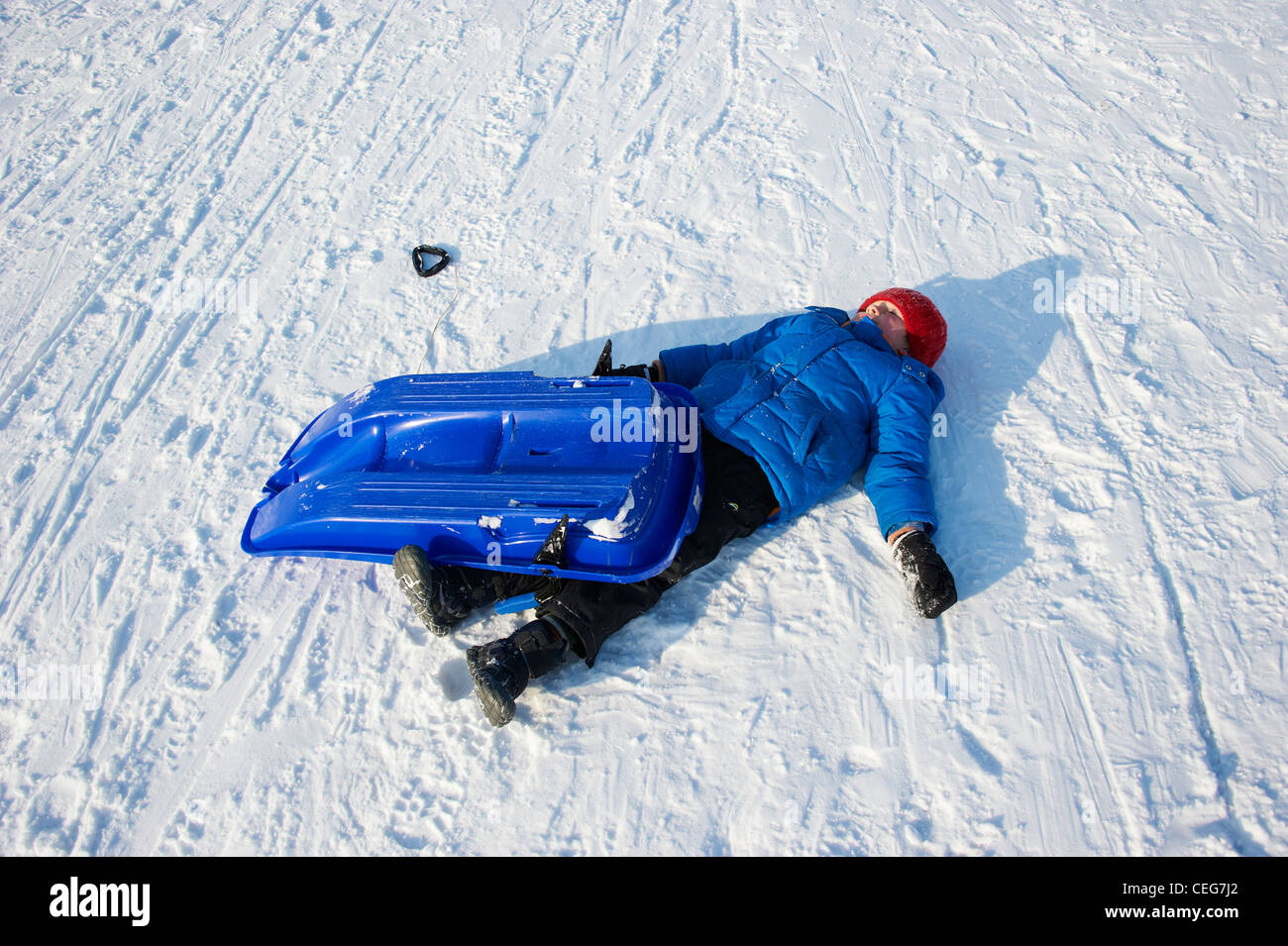 A child little boy sledding downhill winter Stock Photo - Alamy