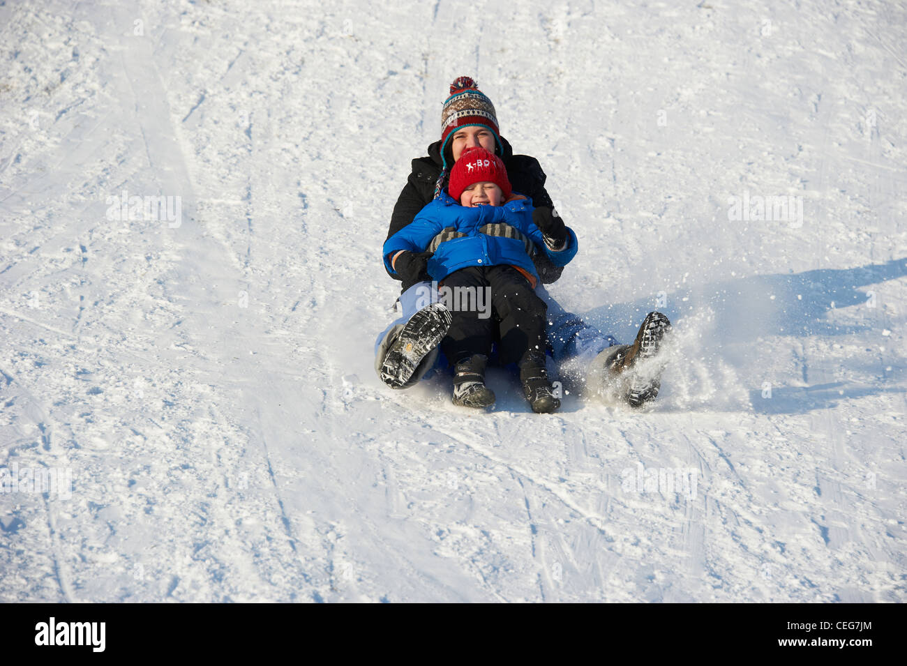 A child little boy sledding downhill winter Stock Photo - Alamy