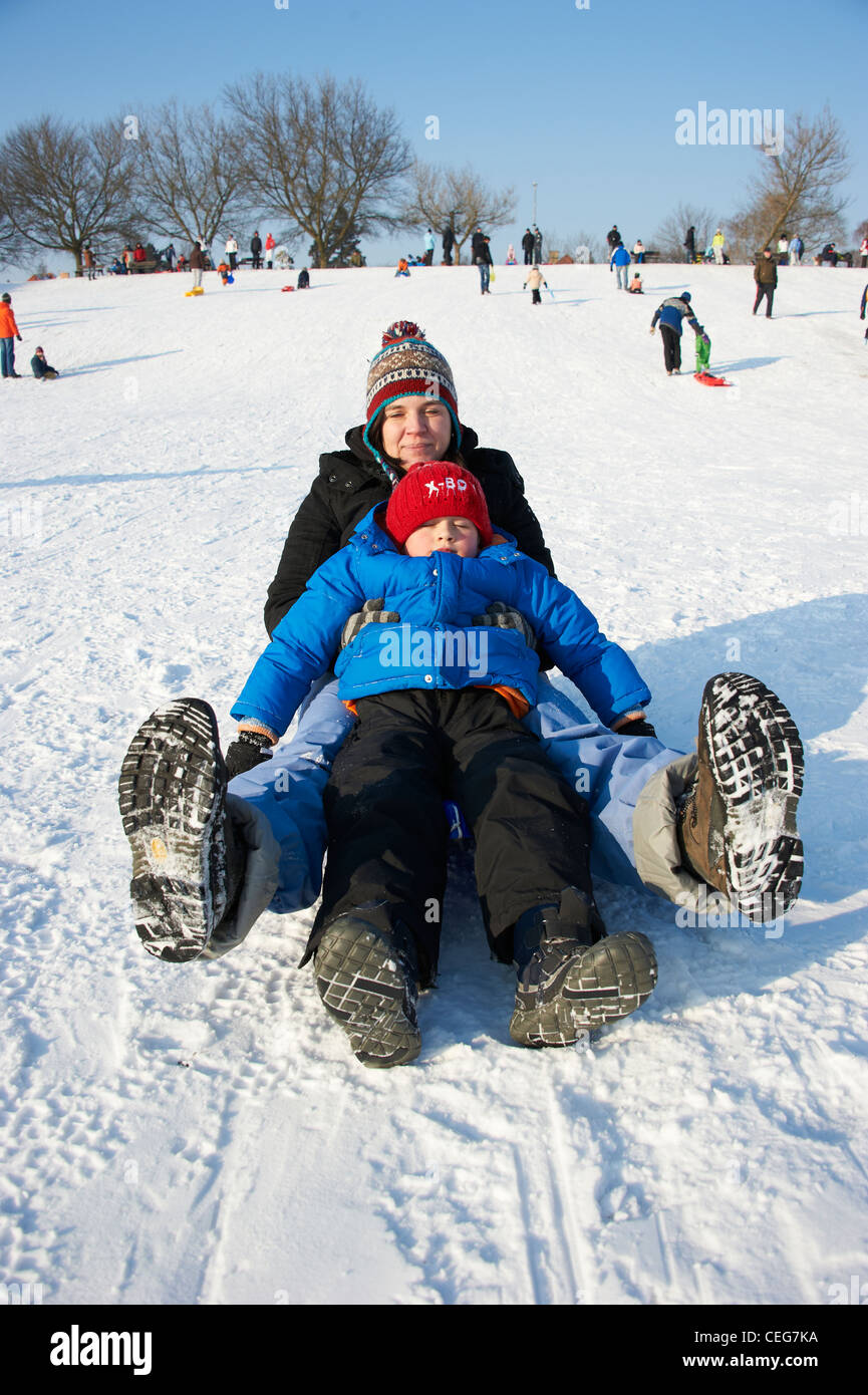 A child little boy sledding downhill winter Stock Photo - Alamy
