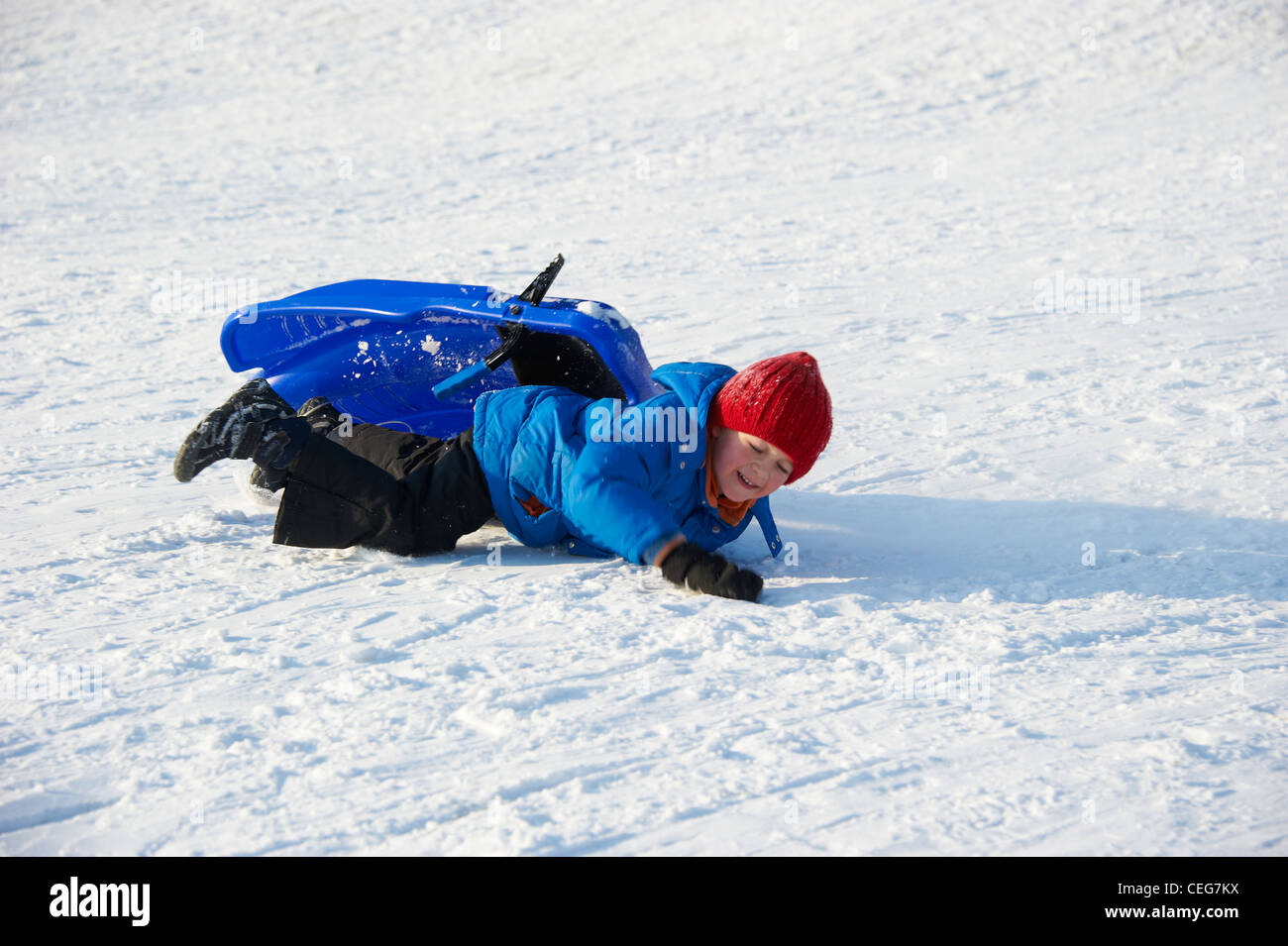 A child little boy sledding downhill winter Stock Photo - Alamy