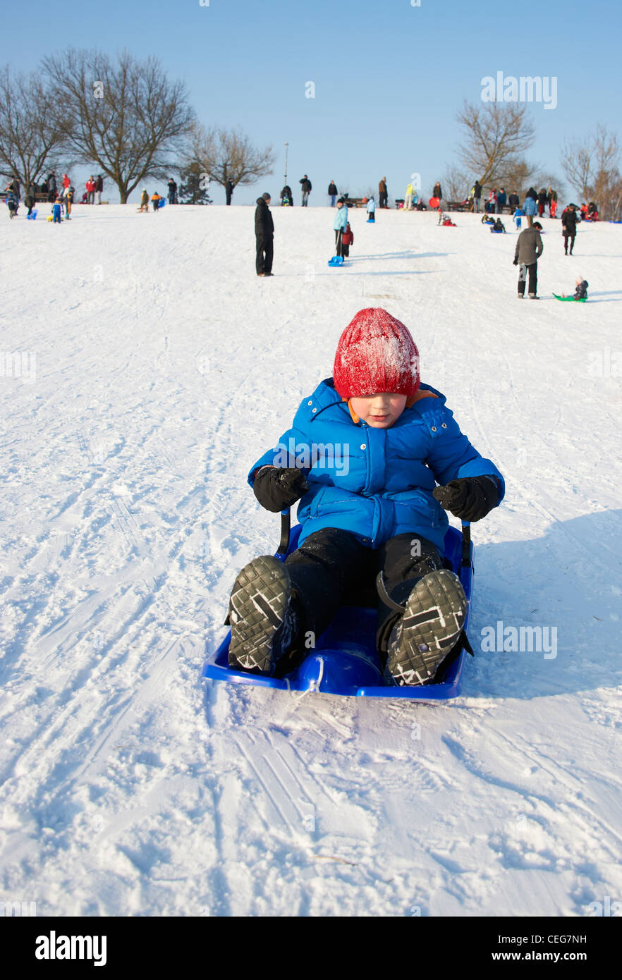 A child little boy sledding downhill winter Stock Photo - Alamy