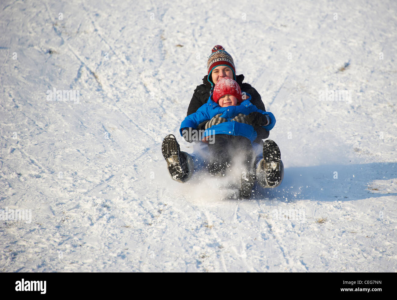 A child little boy sledding downhill winter Stock Photo - Alamy