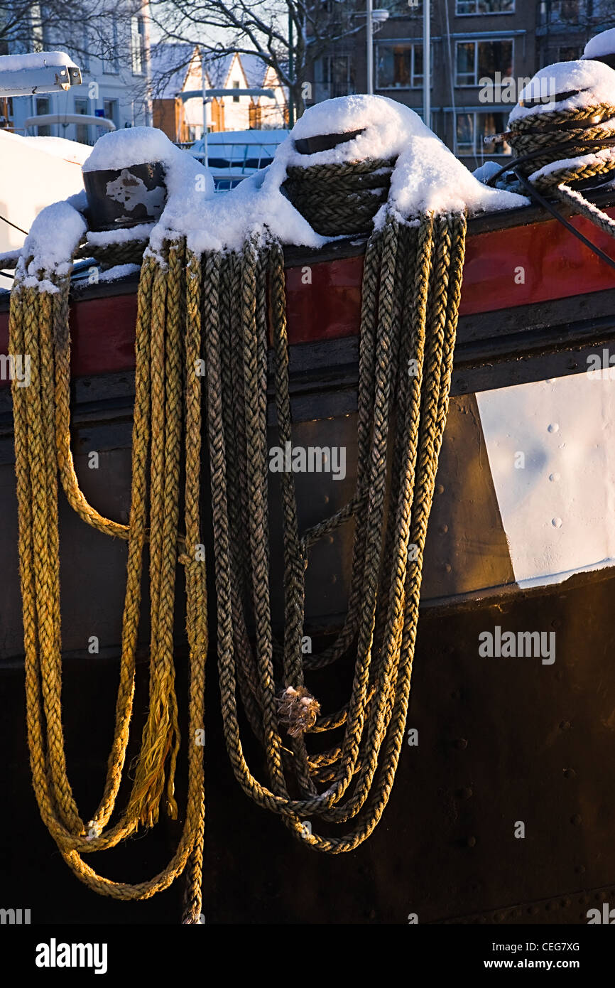Ropes on ship in morning sun covered with snow - vertical image Stock ...