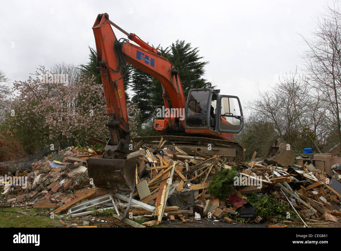 jcb heavy moving excavator earth mover demolishing a building on a ...