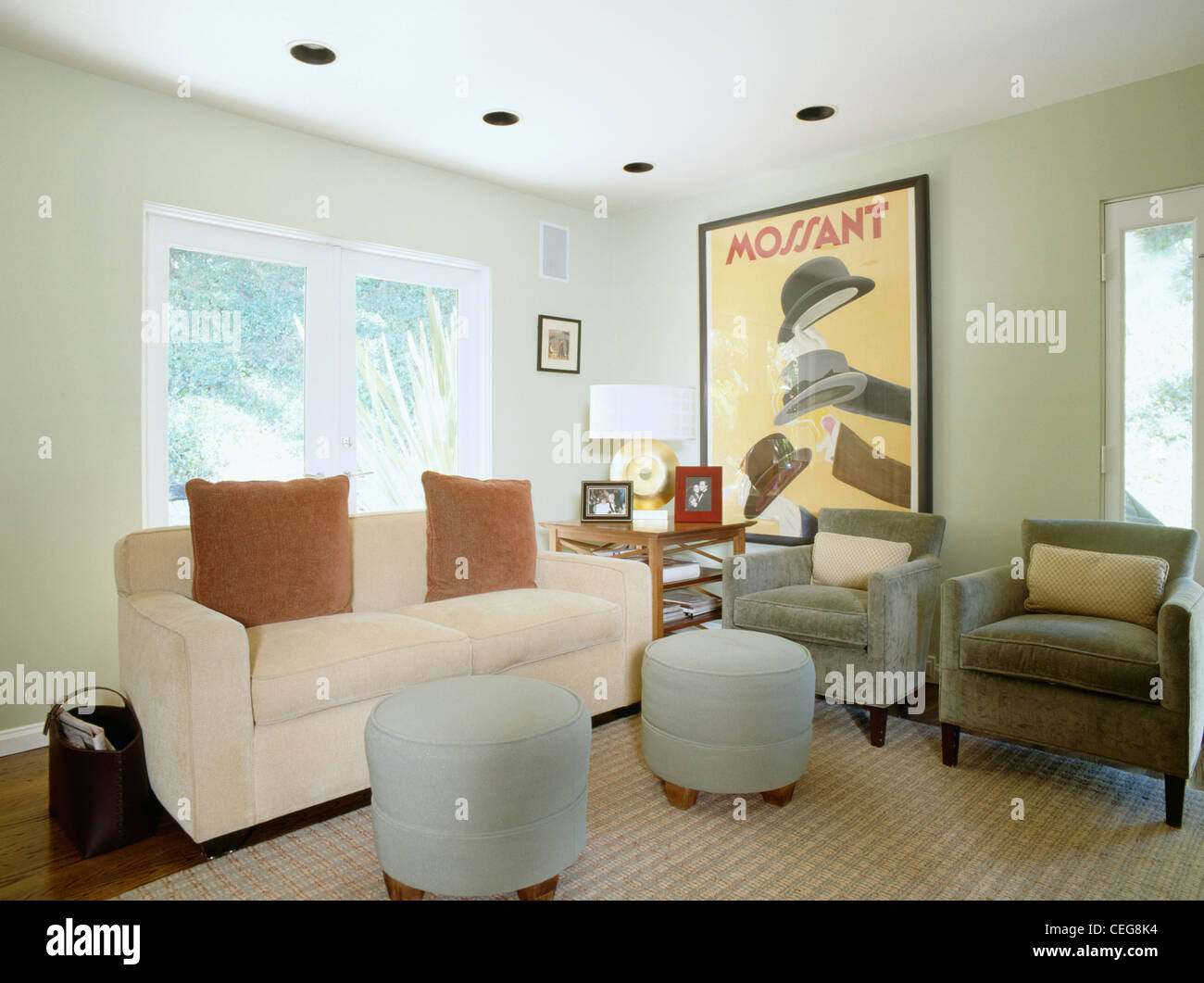 Cream suede leather sofa and gray upholstered stools in modern living ...