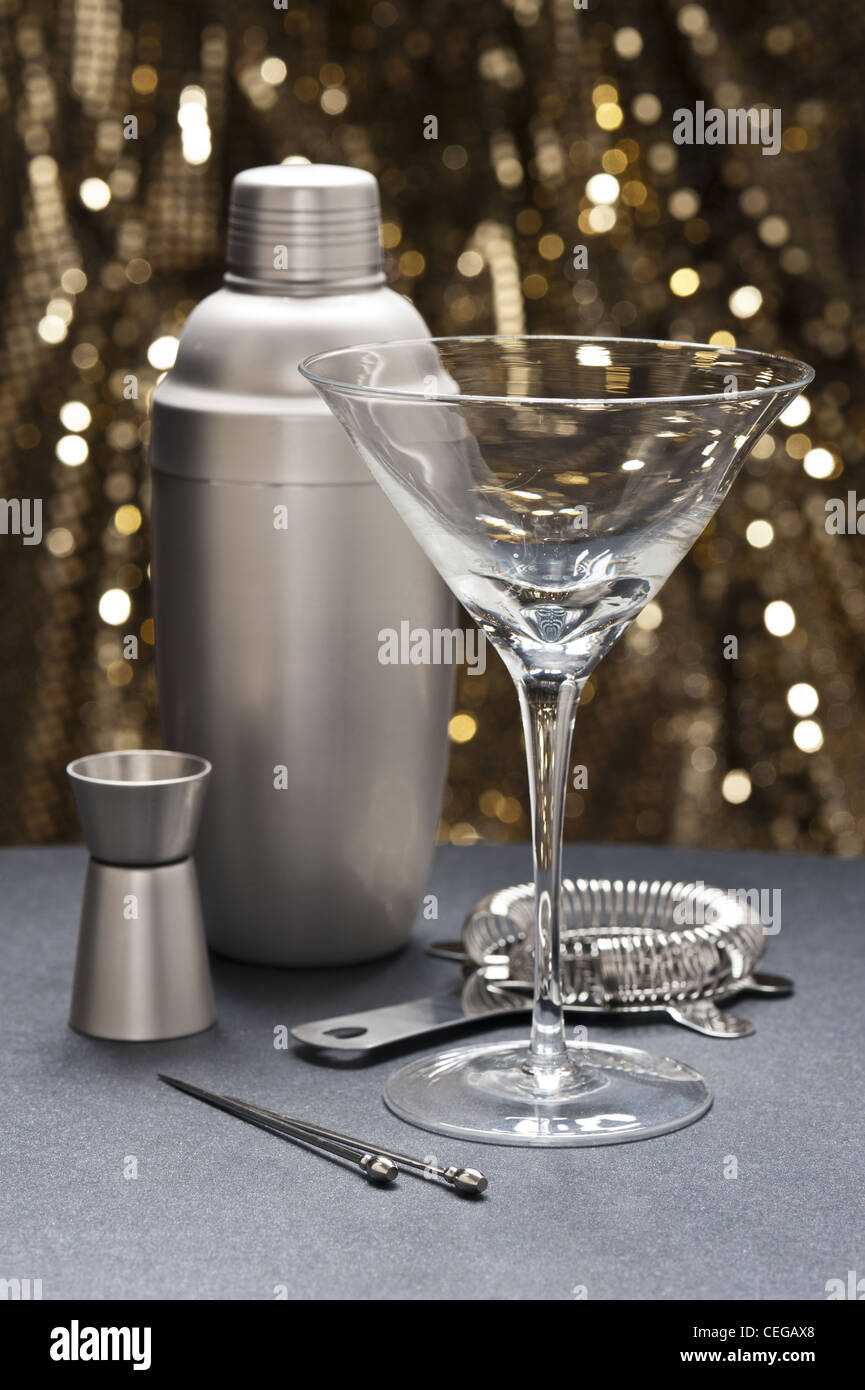 Glasses, Bartender tools in front of a gold glitter background in front ...