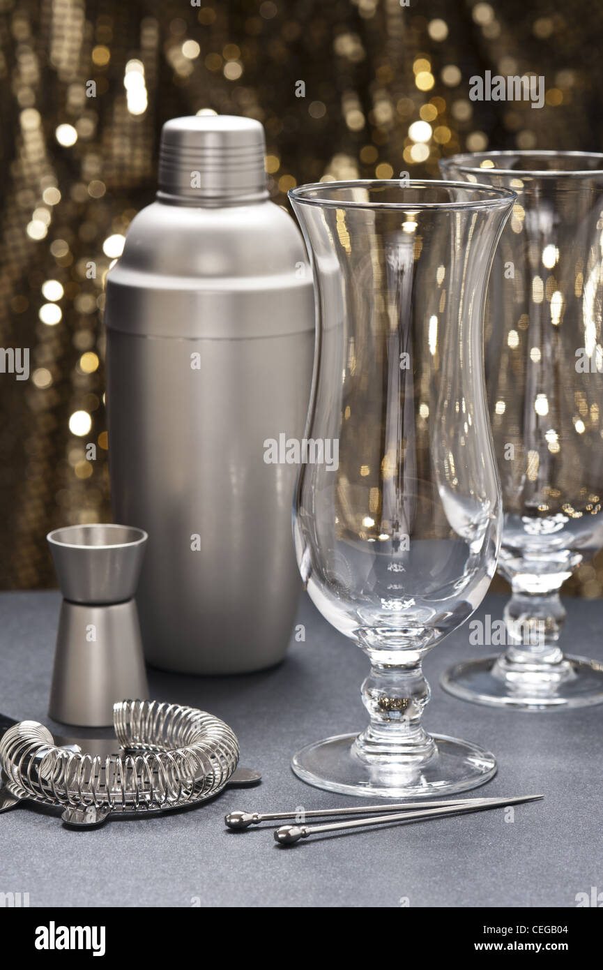 Glasses, Bartender tools in front of a gold glitter background in front ...