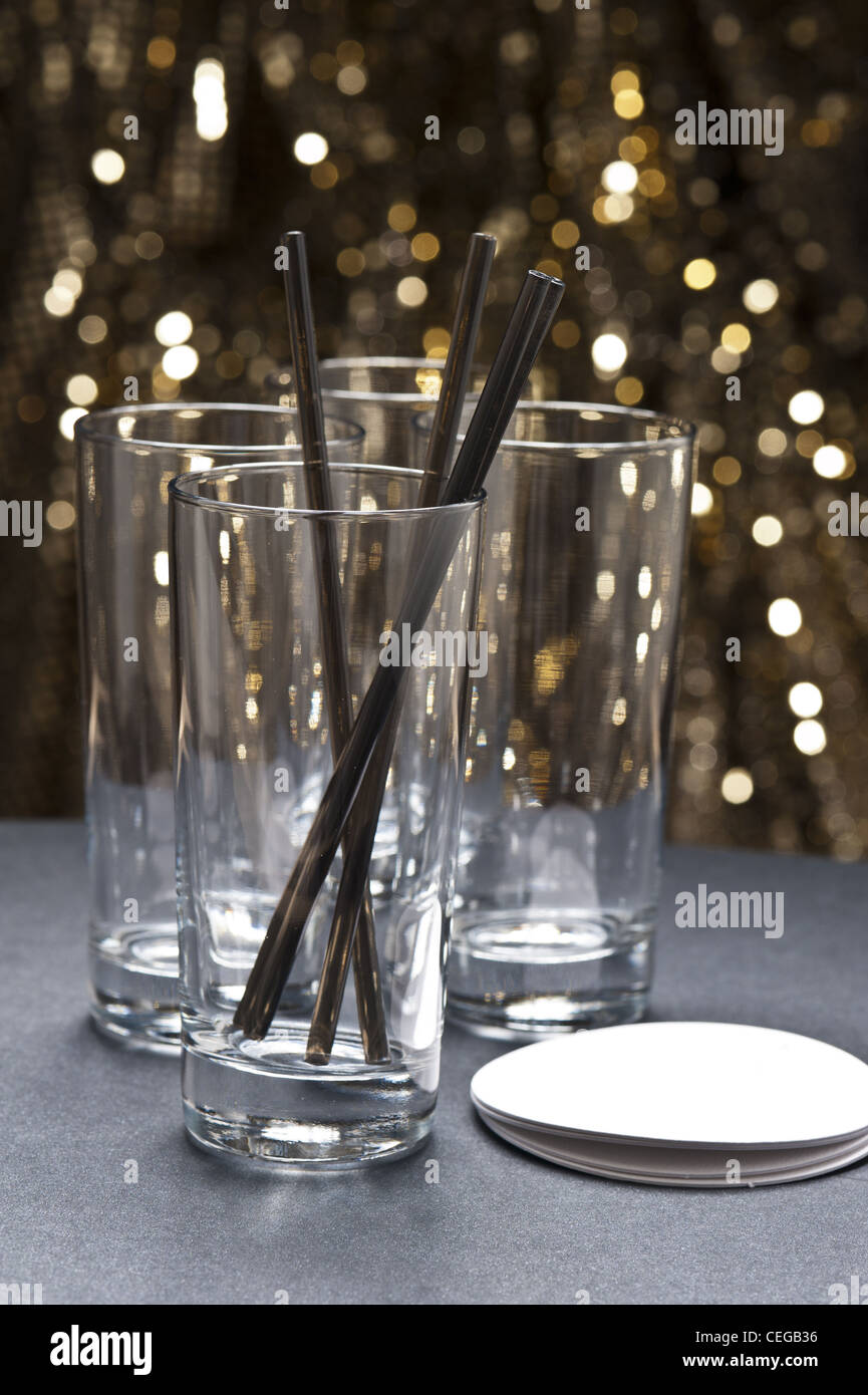 Glasses, Bartender tools in front of a gold glitter background in front ...