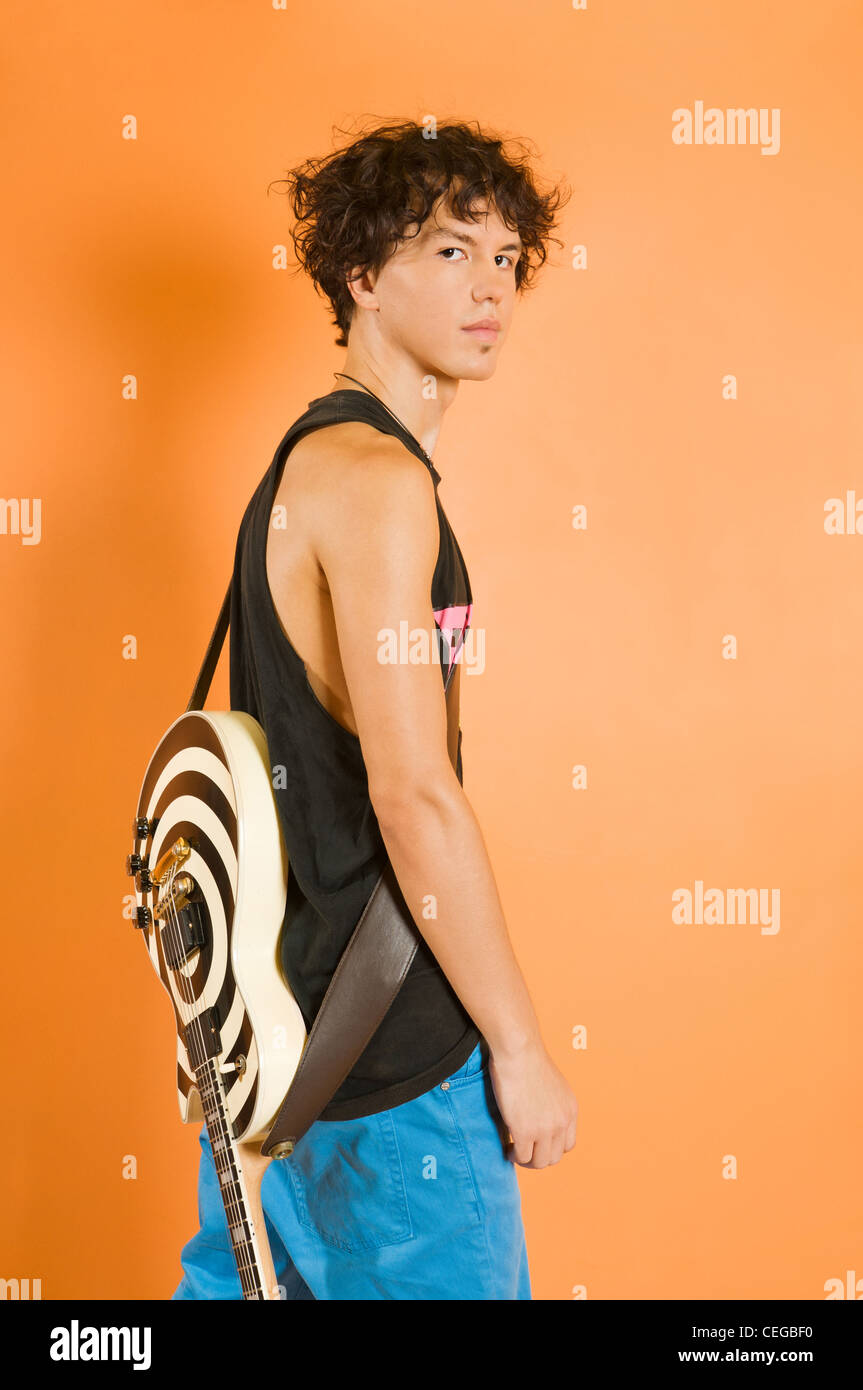 Portrait of a young guitar player at the vivid background Stock Photo ...