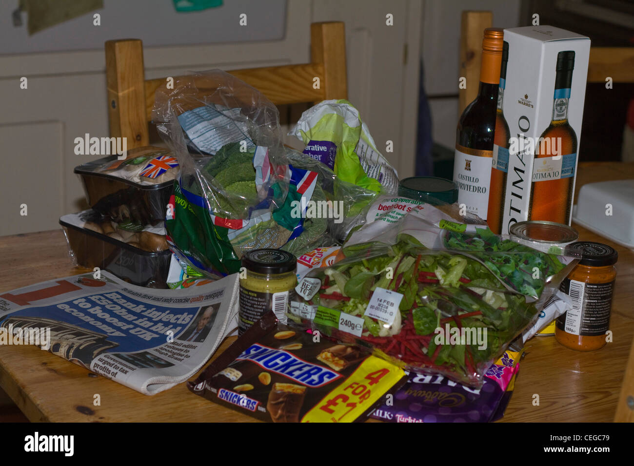 A pile of grocery shopping on a kitchen table Stock Photo - Alamy