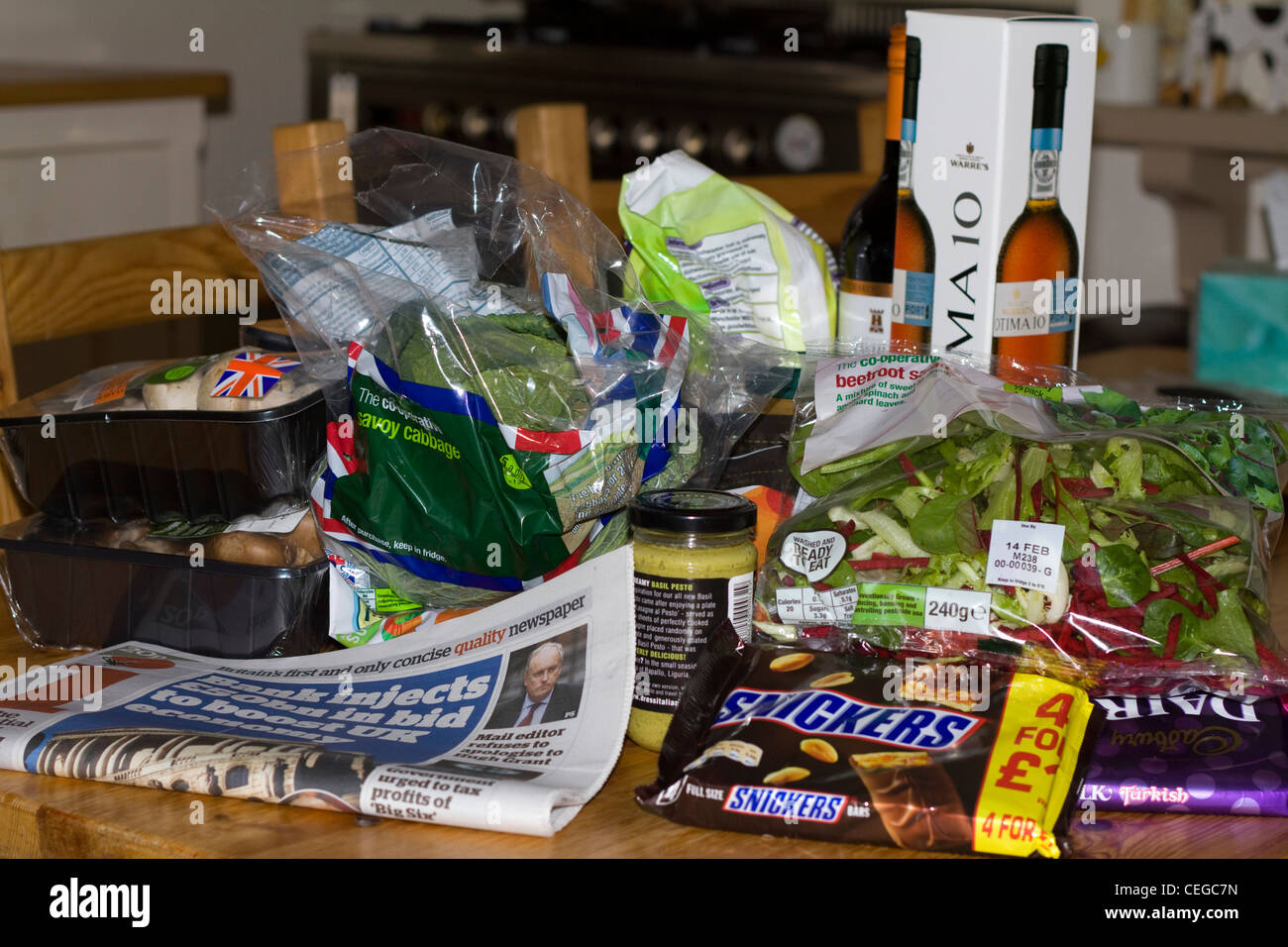 A pile of grocery shopping on a kitchen table Stock Photo - Alamy
