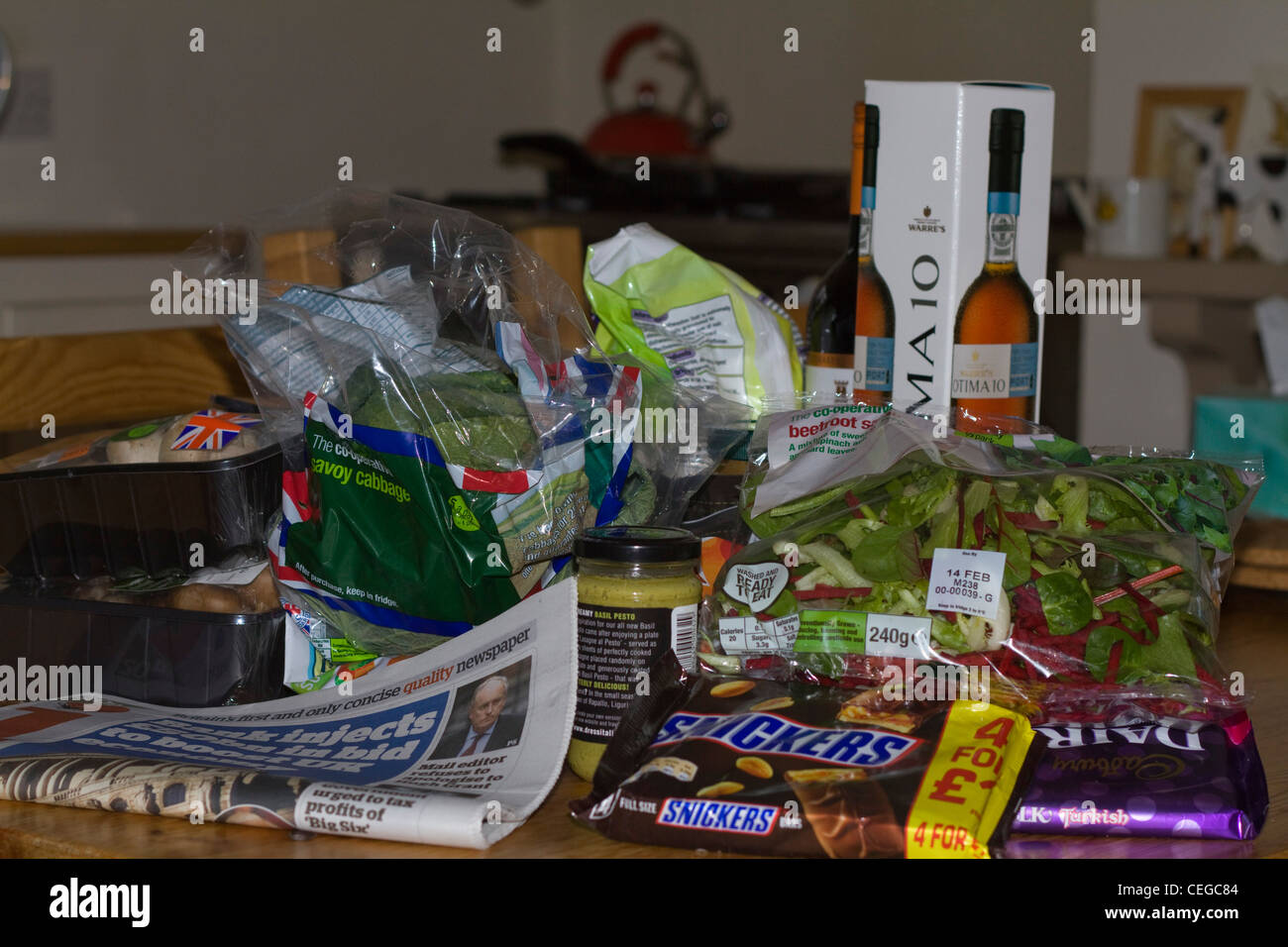 A pile of grocery shopping on a kitchen table Stock Photo - Alamy