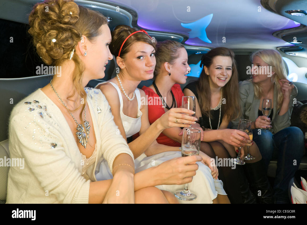 Young women celebrating at the limousine Stock Photo - Alamy
