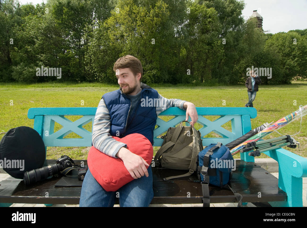 Two young photographers after a shooting session in a park Stock Photo ...