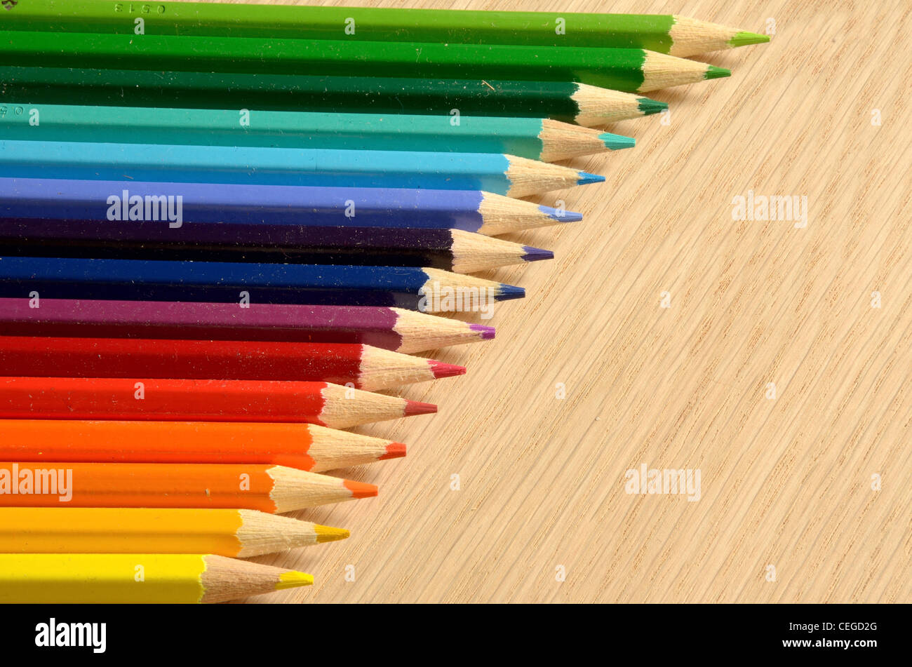 Beautiful colored pencils on a wood texture Stock Photo - Alamy