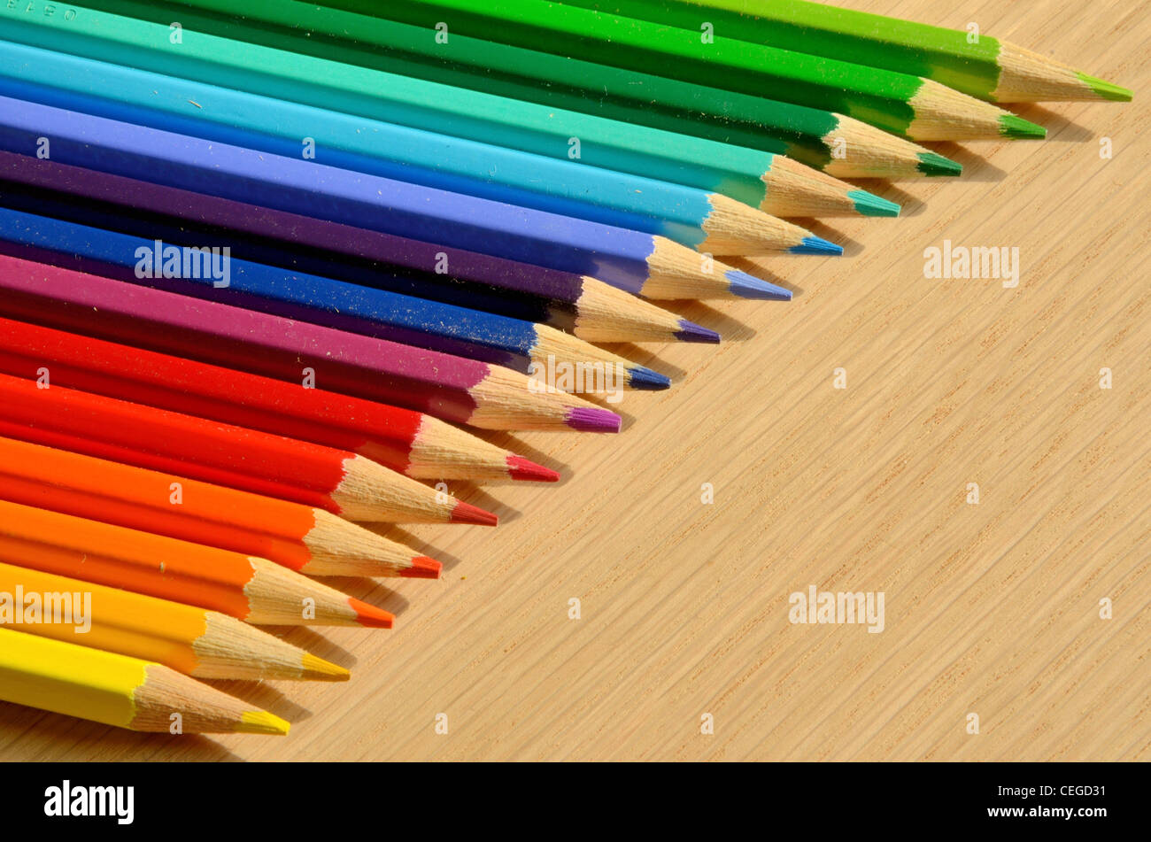 Beautiful colored pencils on a wood texture Stock Photo - Alamy
