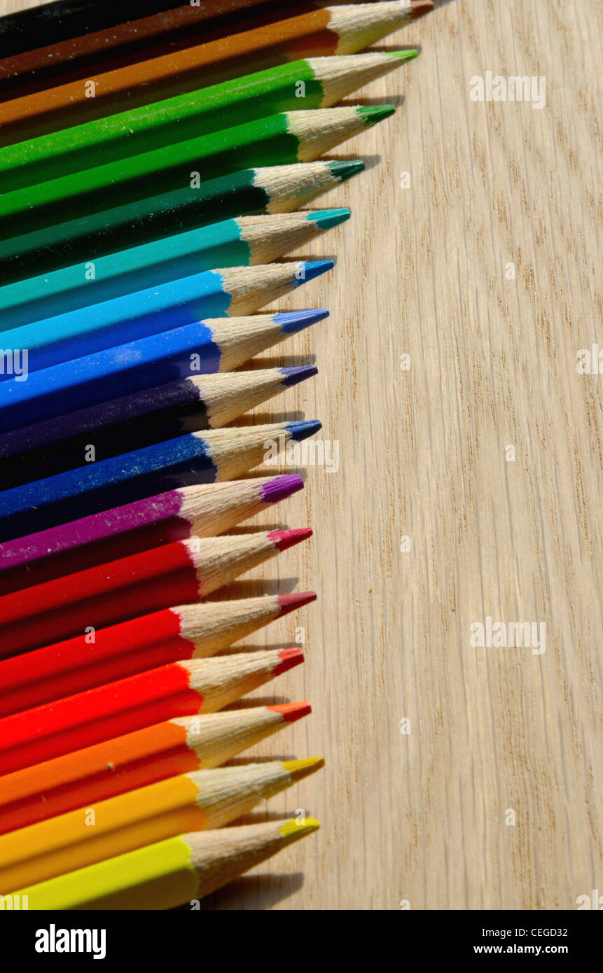 Beautiful colored pencils on a wood texture Stock Photo - Alamy