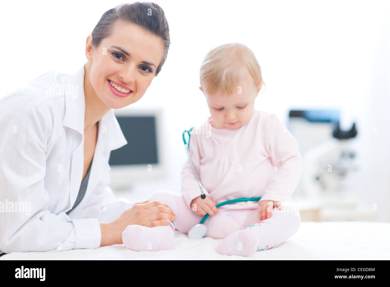 Pediatric doctor with baby on survey Stock Photo - Alamy