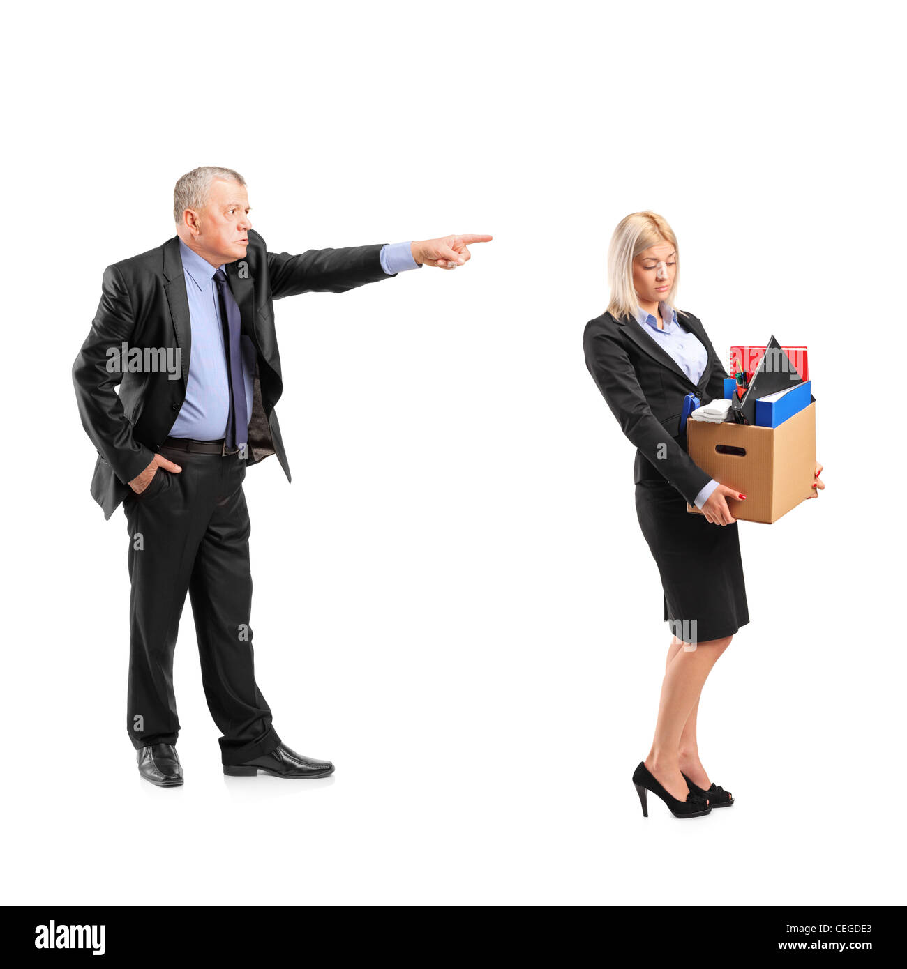 Full length portrait of an angry boss firing a woman in a suit carrying ...