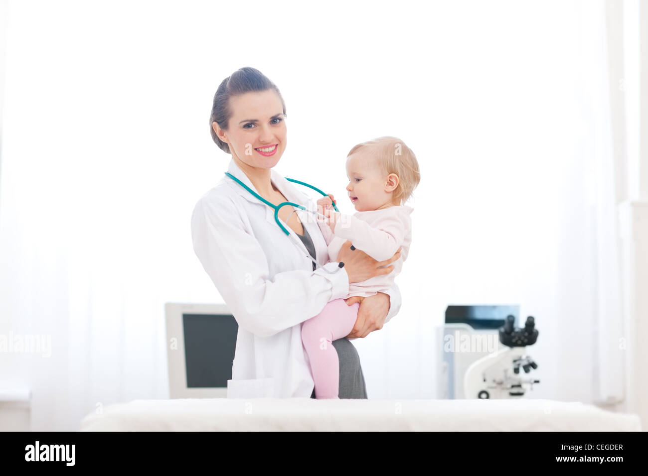 Pediatric doctor and baby on survey Stock Photo - Alamy