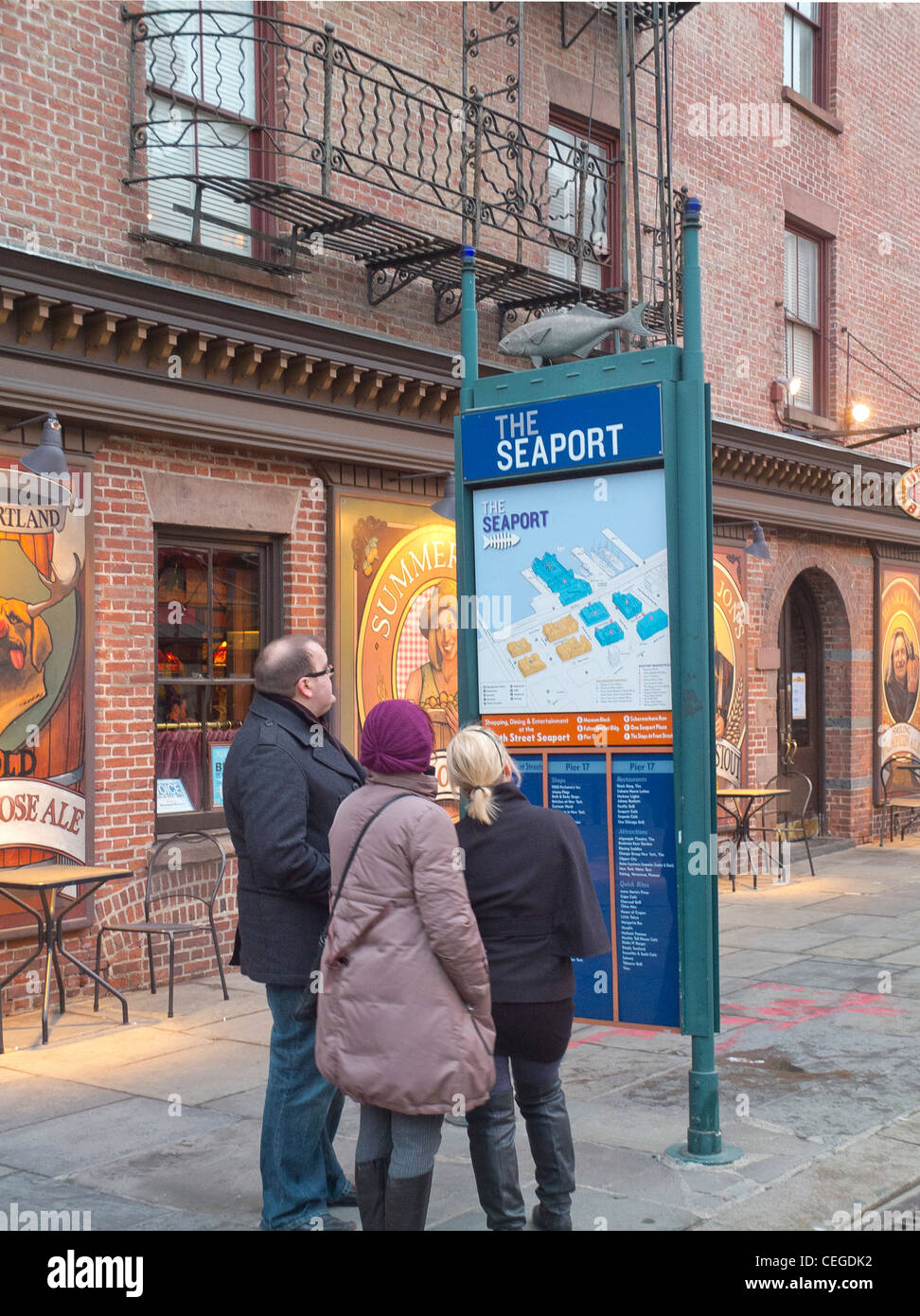 tourists looking at South Street Seaport map Stock Photo - Alamy
