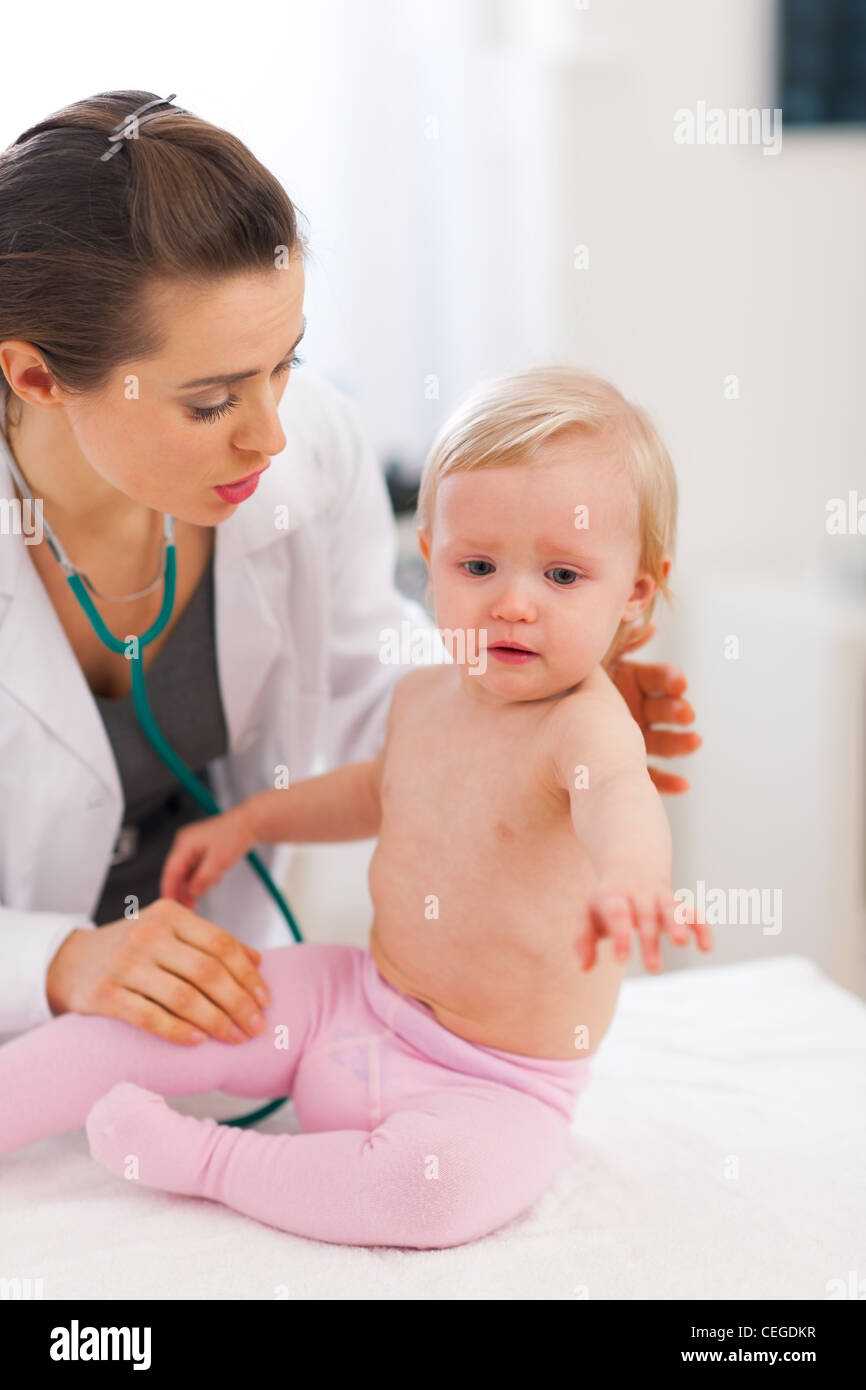 Pediatric doctor calming crying baby Stock Photo - Alamy