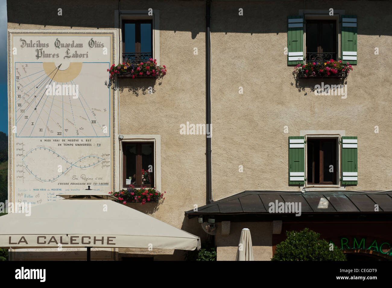 Astronomical clock and sun dial beside shuttered windows in Place de l ...