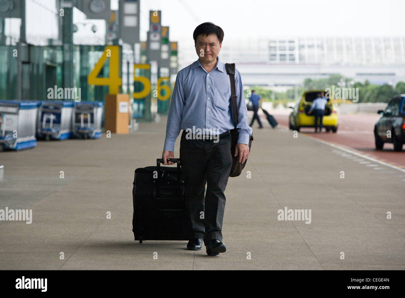 A passenger arrives to check in for a flight at Terminal Three at ...