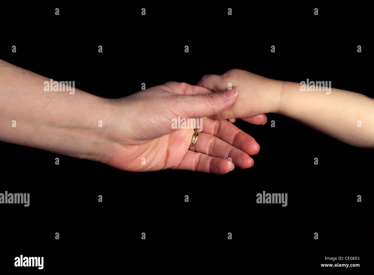 Mother Holding Daughters Hand Isolated on Black Stock Photo - Alamy