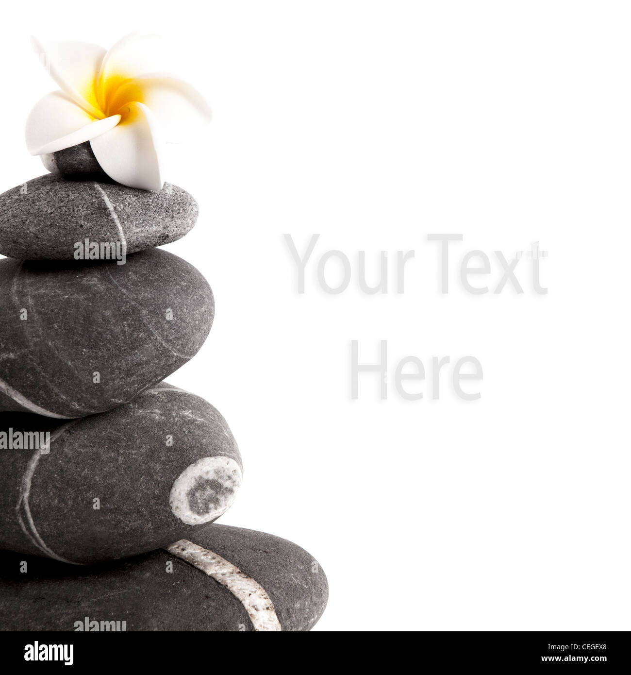 Stones pyramid with a plumeria flower, isolated on white background ...