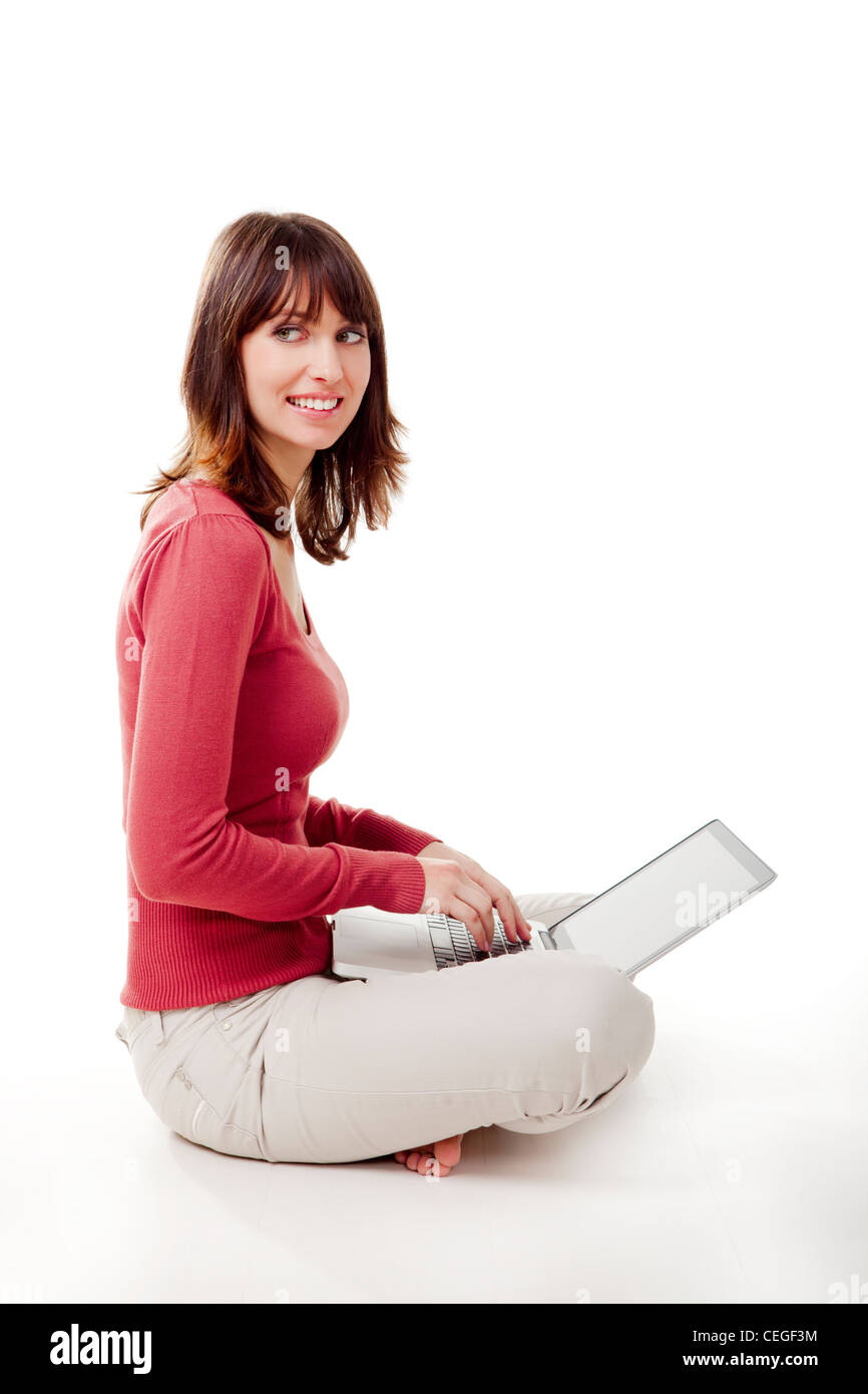 Beautiful woman sitting on the floor and working with a laptop Stock ...