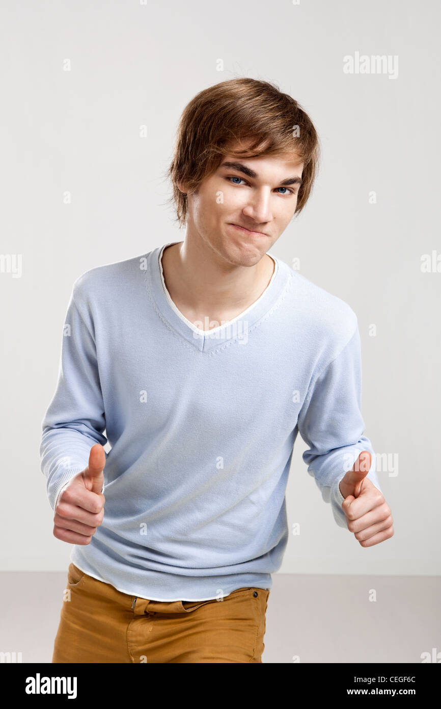 Portrait of a handsome young man thinking, over a gray background Stock ...