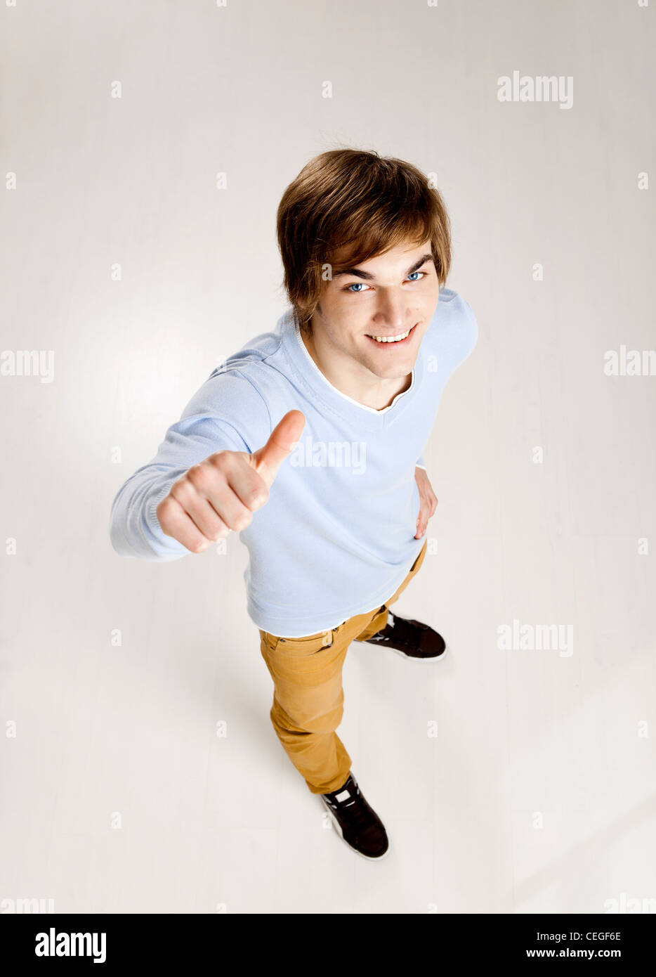 Portrait of a handsome young man thinking, over a gray background Stock ...